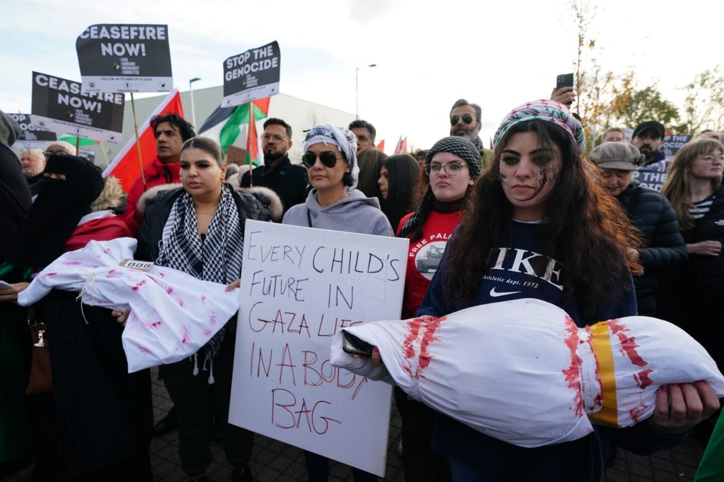 Protesters hold up mock body bags in protest at Gaza war – The Irish News
