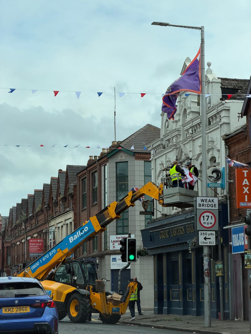 Police drive past as mechanical equipment used to put up union and ...